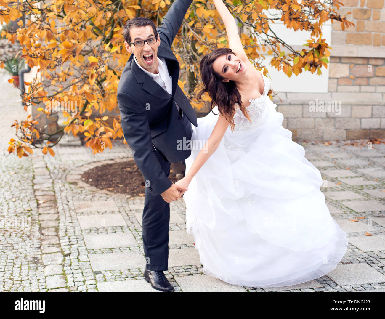 Laughing wedding couple in fancy pose Stock Photo - Alamy