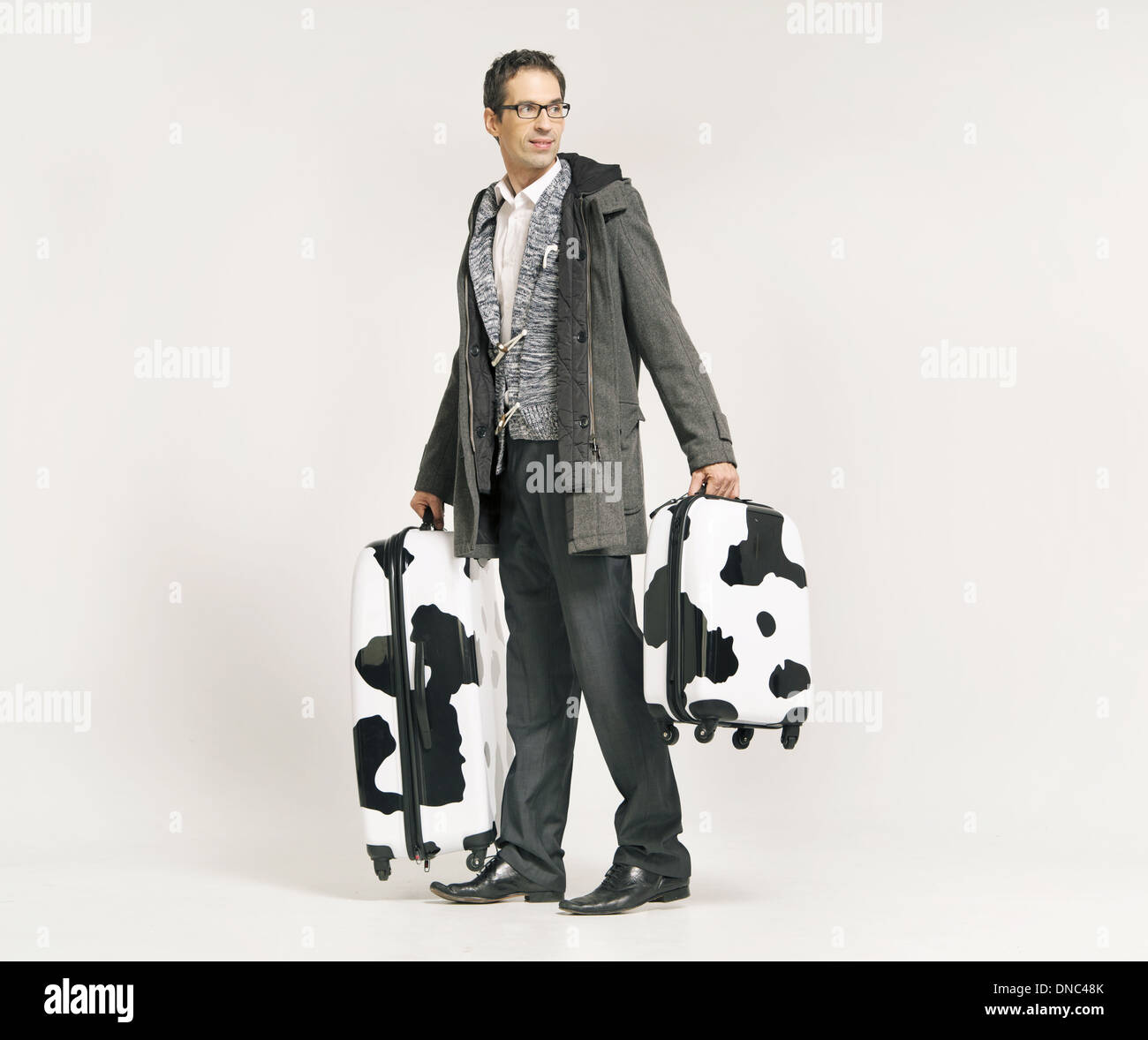 Elegant tall guy with suitcases Stock Photo - Alamy