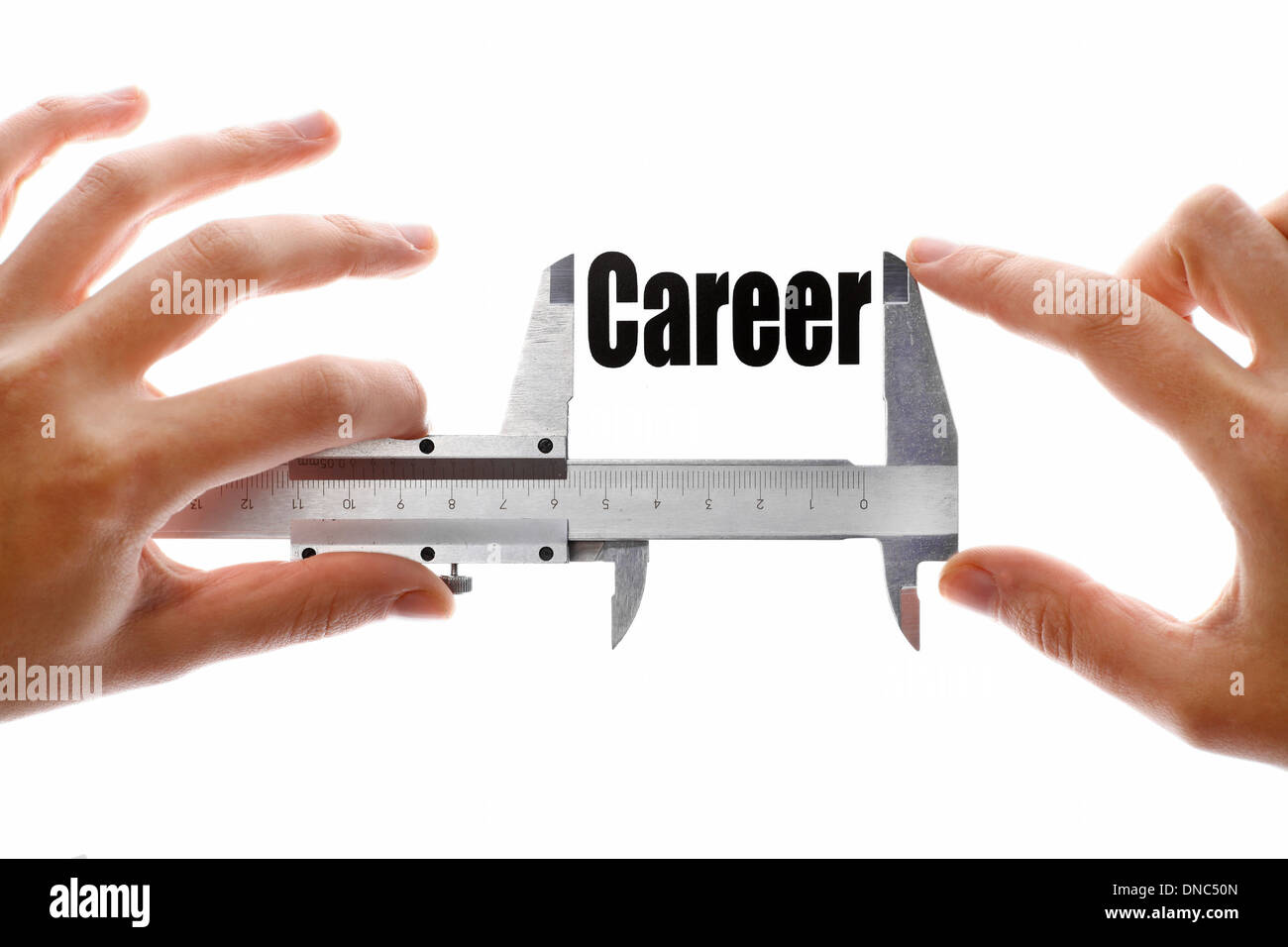 Two hands holding a caliper, measuring the word "Career Stock Photo - Alamy