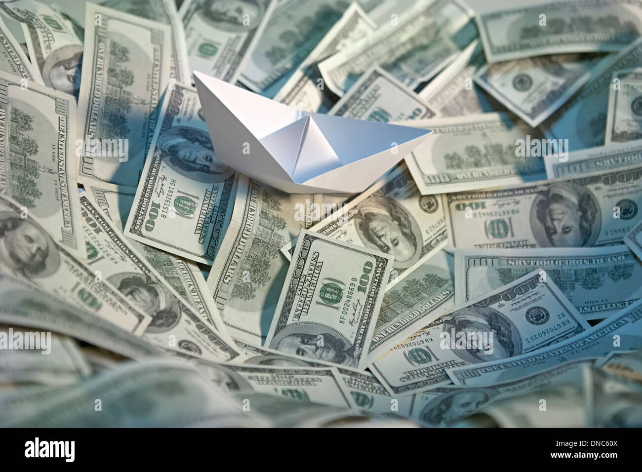 Paper boat at sea of money Stock Photo - Alamy