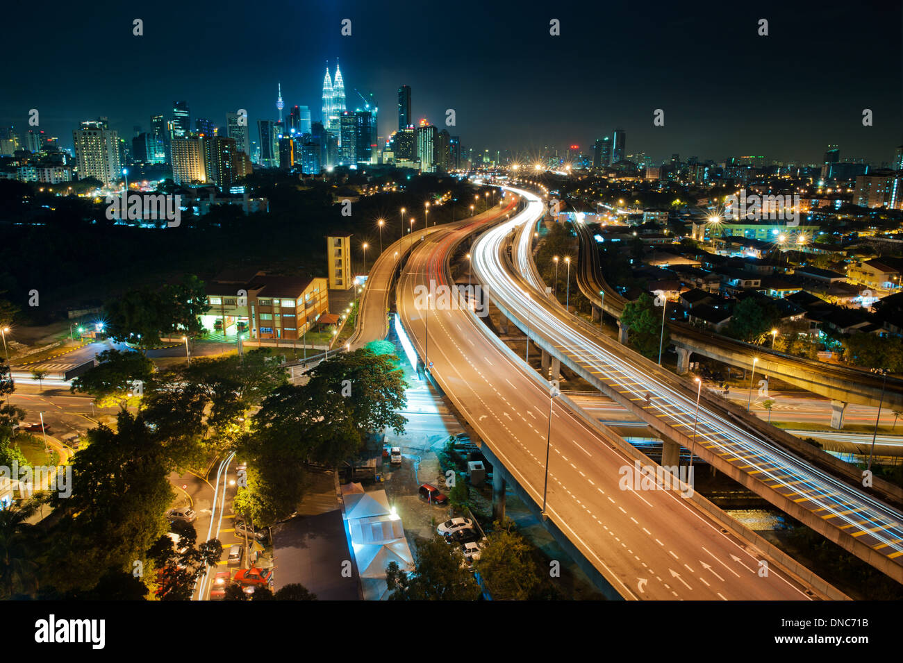 Light trails snaking down Kuala Lumpur highway from the city center and ...