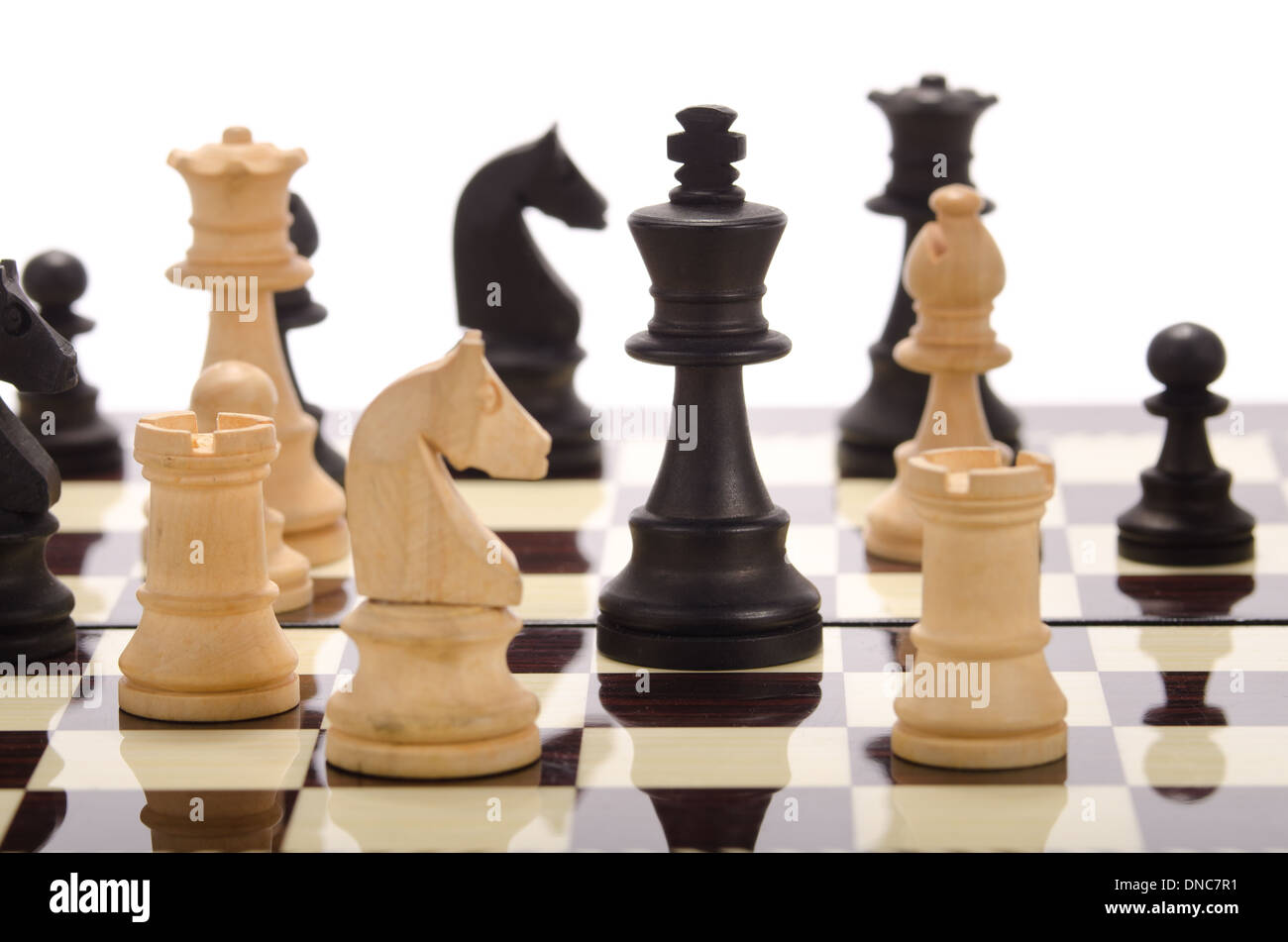 traditional wooden chess pieces on chessboard in different positions ...