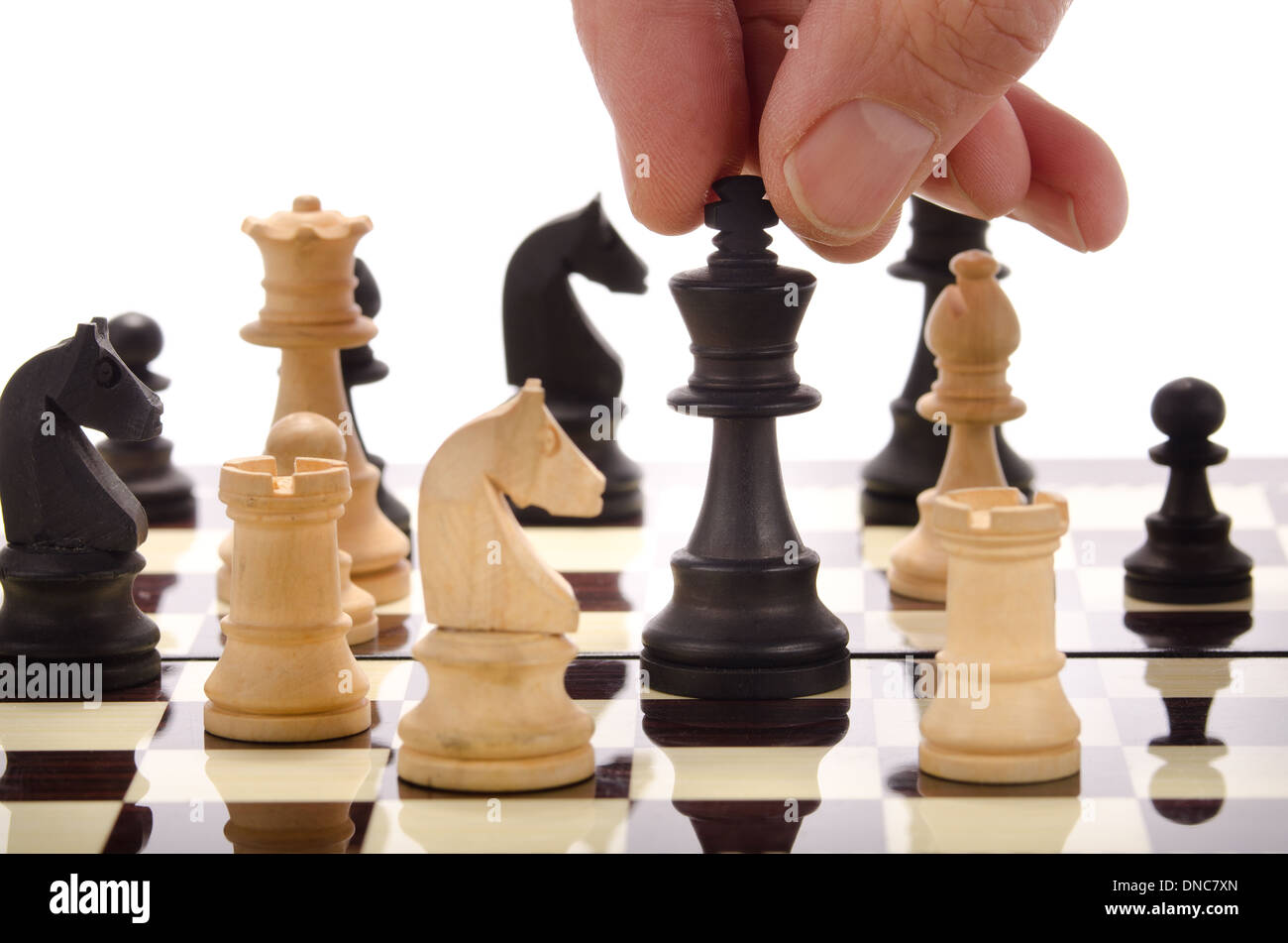 traditional wooden chess pieces on chessboard in different positions ...