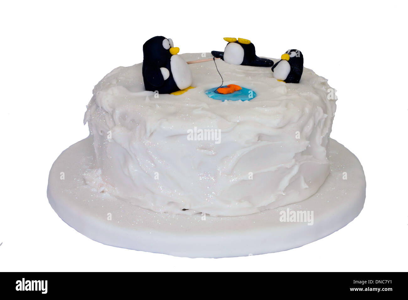 Homemade Penguin Cake: showing a fishing penguin on an iced cake Stock ...