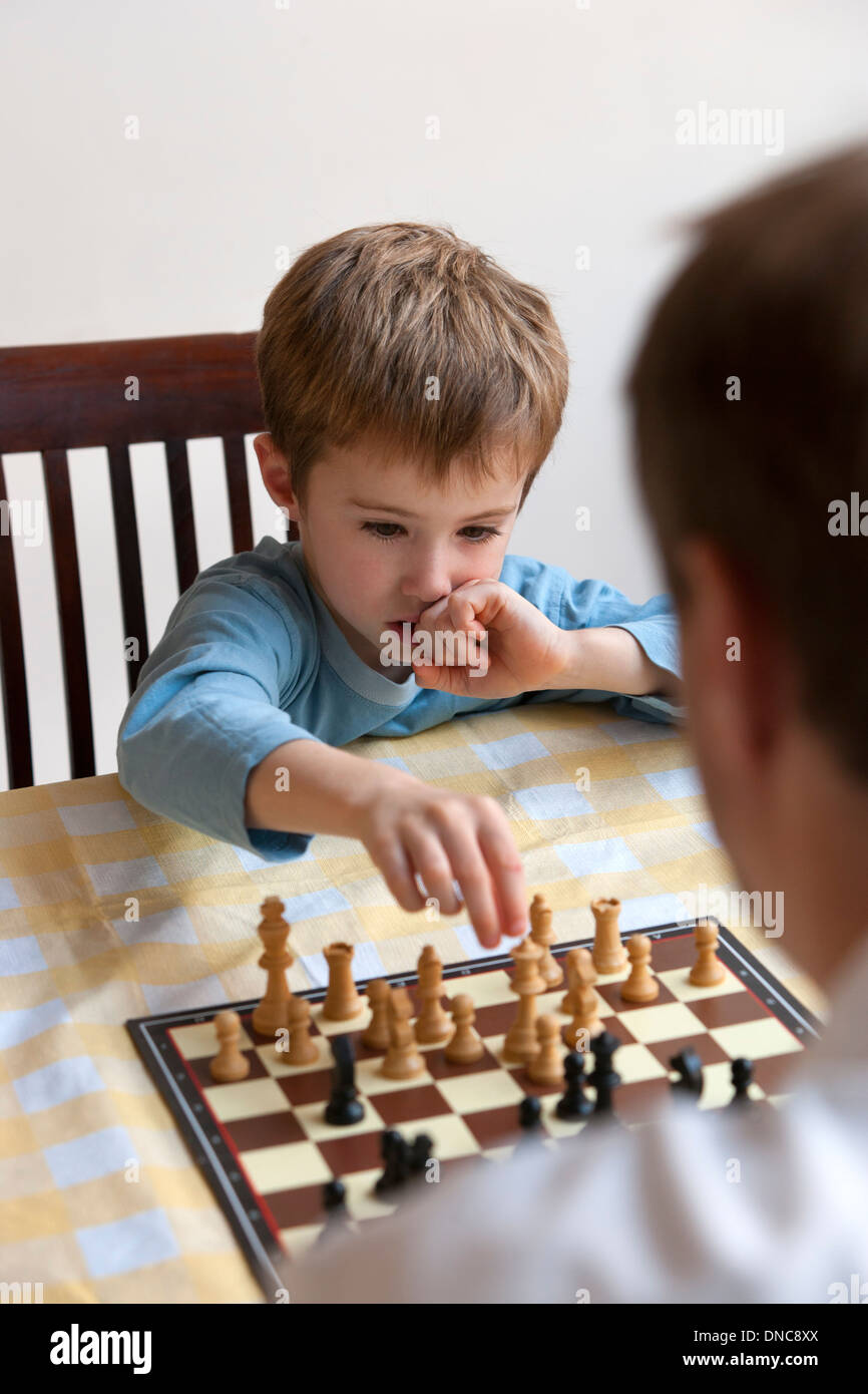 Little boy is playing chess Stock Photo - Alamy