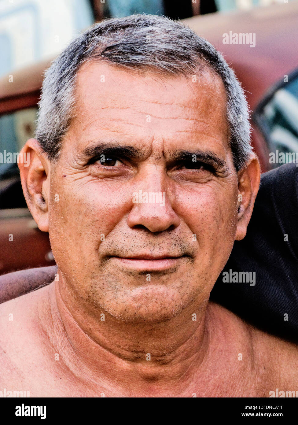 Close up of a topless Cuban man with a grin on his face Stock Photo - Alamy
