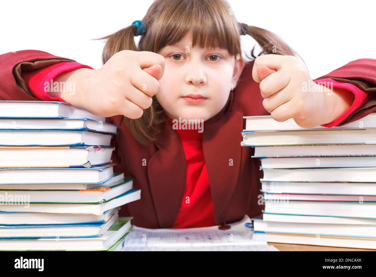 Schoolgirl unwilling to do schoolwork and shows fig Stock Photo - Alamy