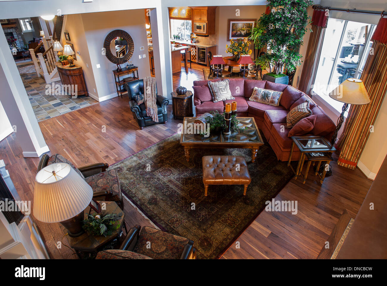 Elevated view of living room in luxury home with view of kitchen and ...