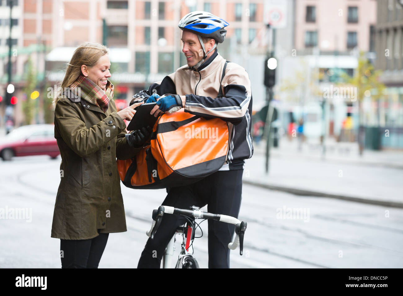 Courier Delivery Man Showing Digital Tablet To Young Woman Stock Photo ...