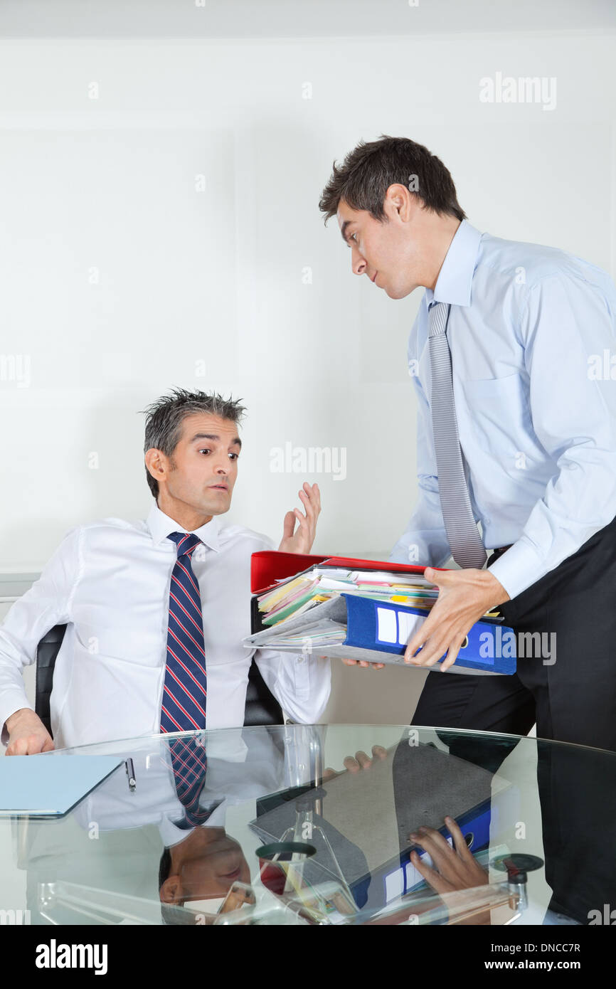 Businessmen Overwhelmed By Load Of Work Stock Photo - Alamy
