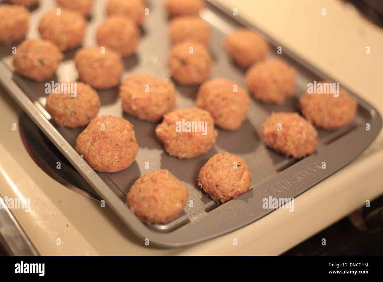 A tray of uncooked chicken meatballs Stock Photo - Alamy