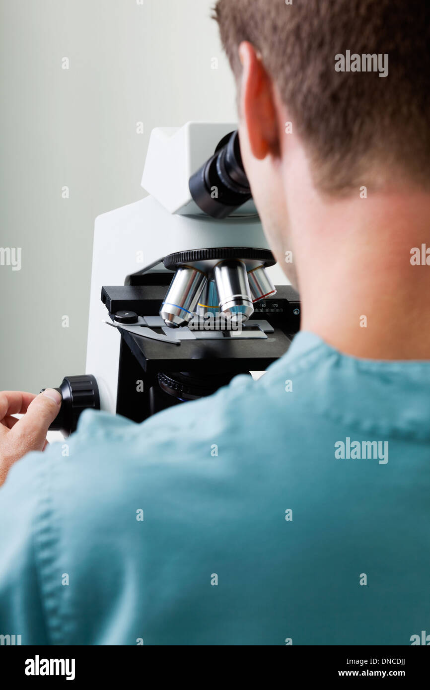 Male Researcher Using Microscope In Laboratory Stock Photo - Alamy