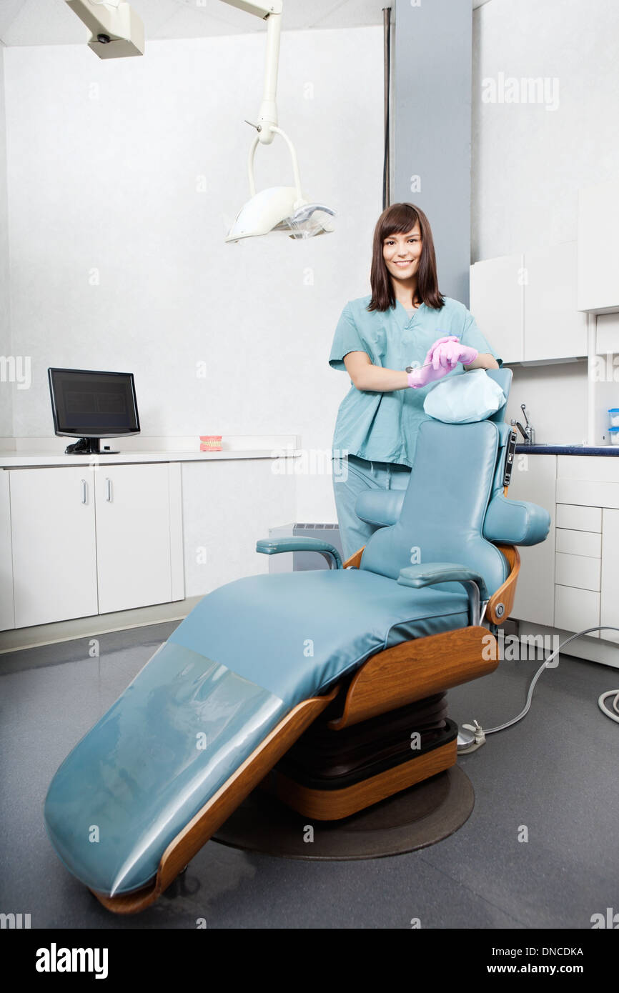 Female Dentist Standing By Dental Chair At Clinic Stock Photo - Alamy