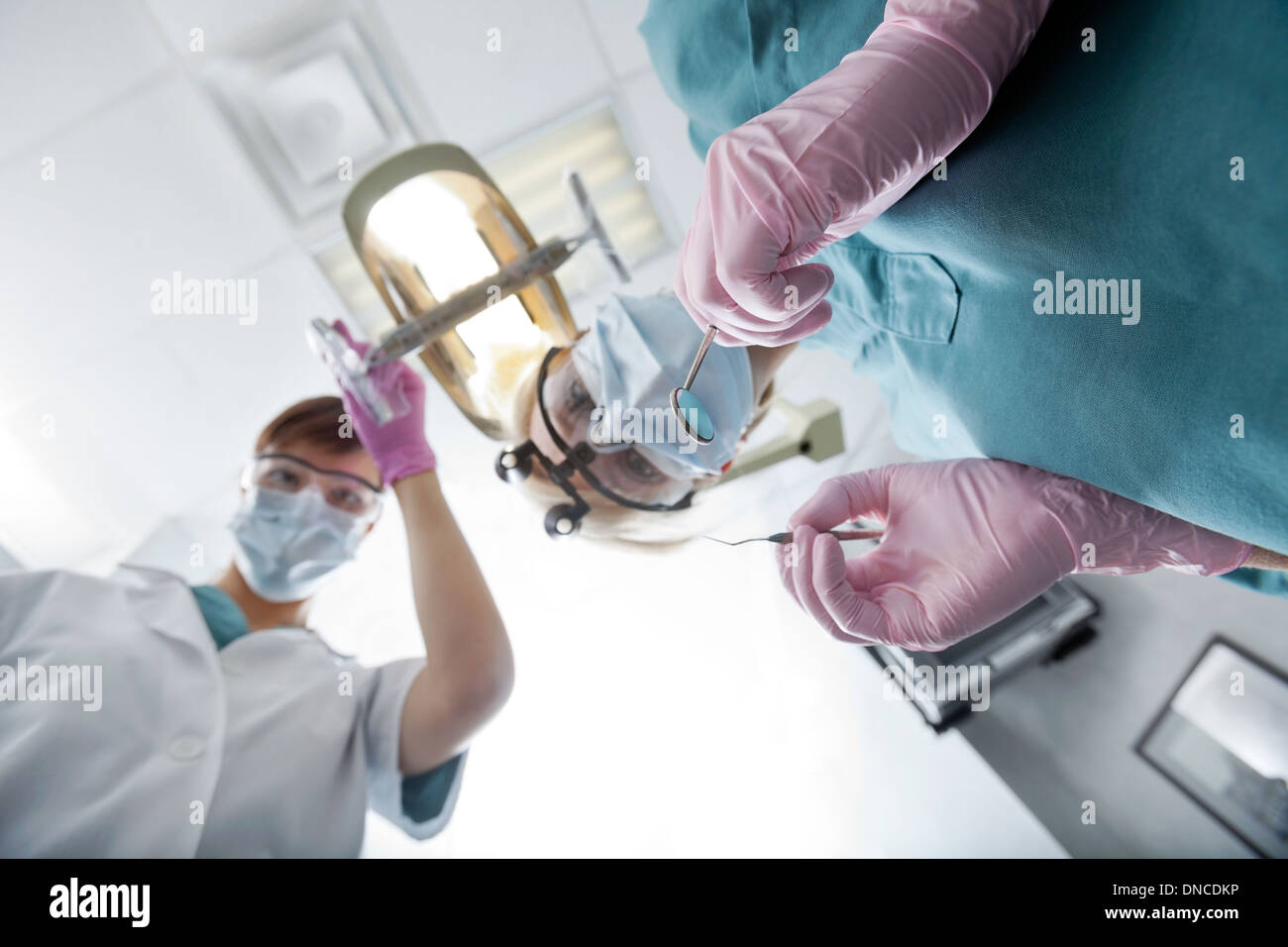 Female Dentist And Assistant Conducting Dental Operation Stock Photo ...