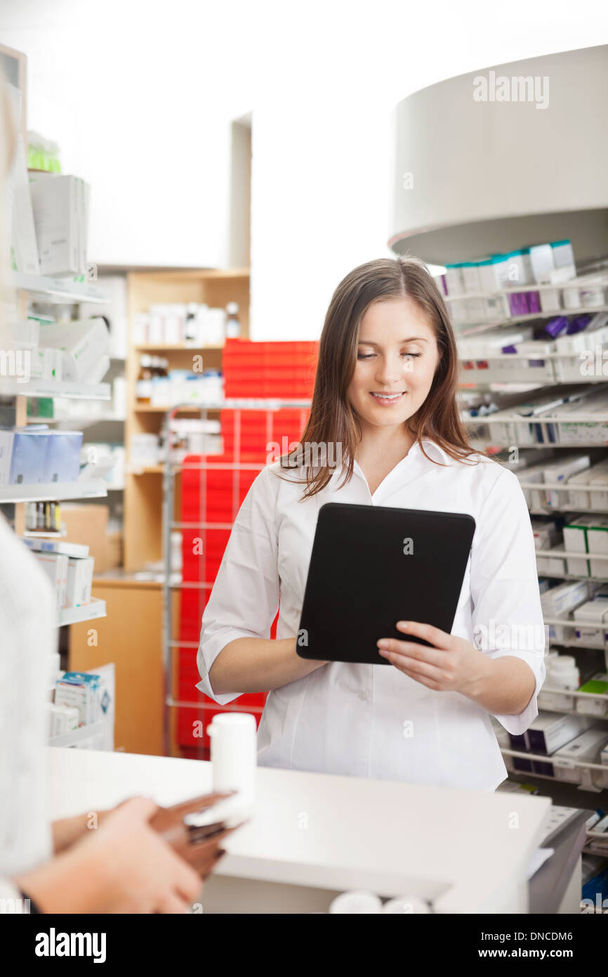 Professional pharmacist helping female customer hi-res stock ...