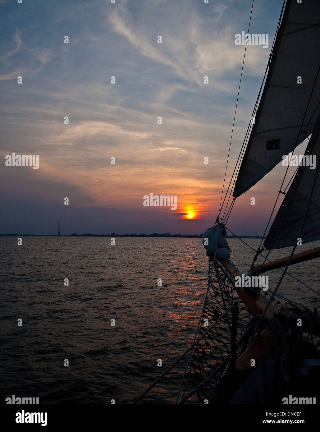 Sunset reflecting on the river in front of a schooner rigging Stock ...