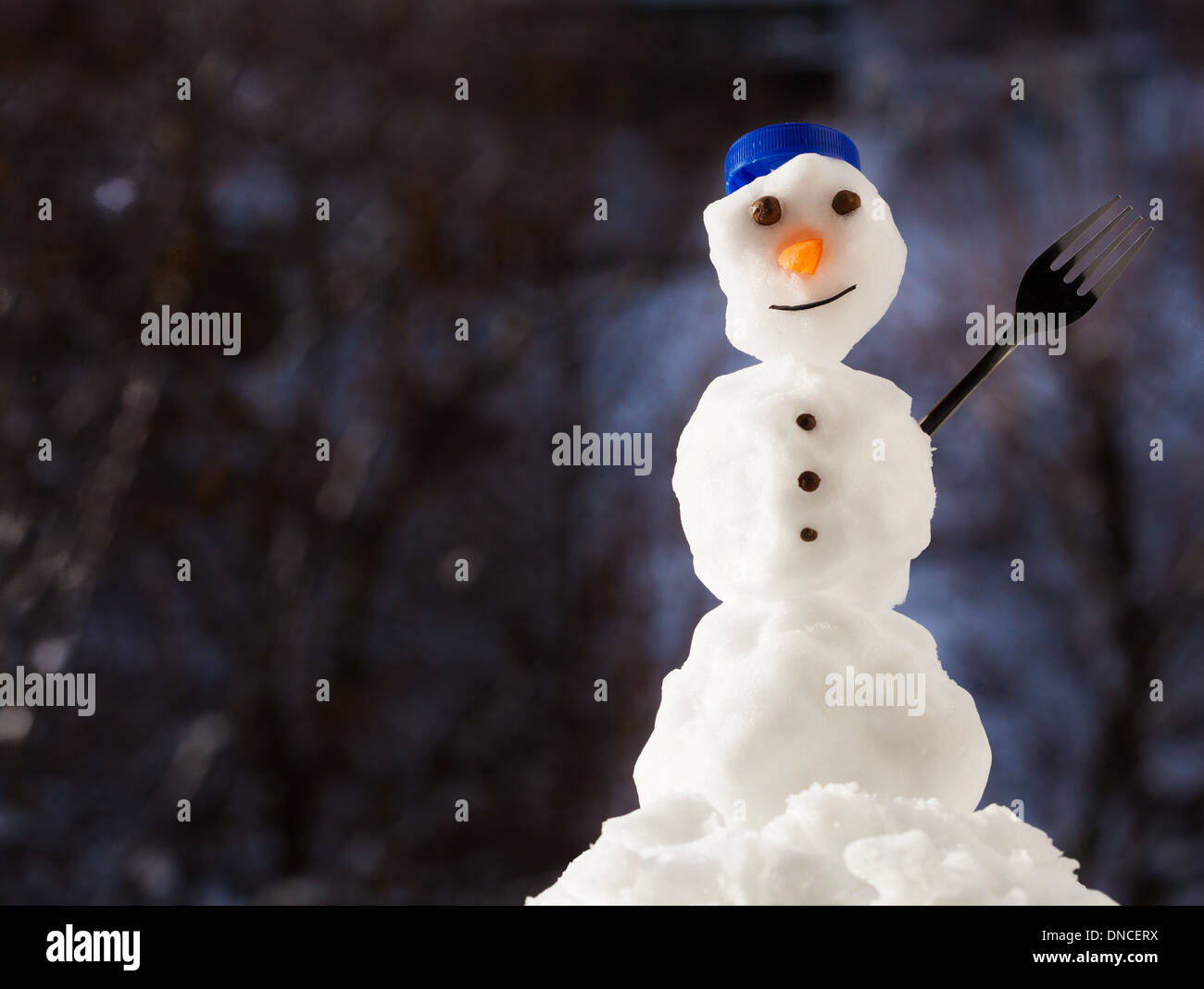 Christmas. Little funny snowman with fork as hand outdoor. Sky ...