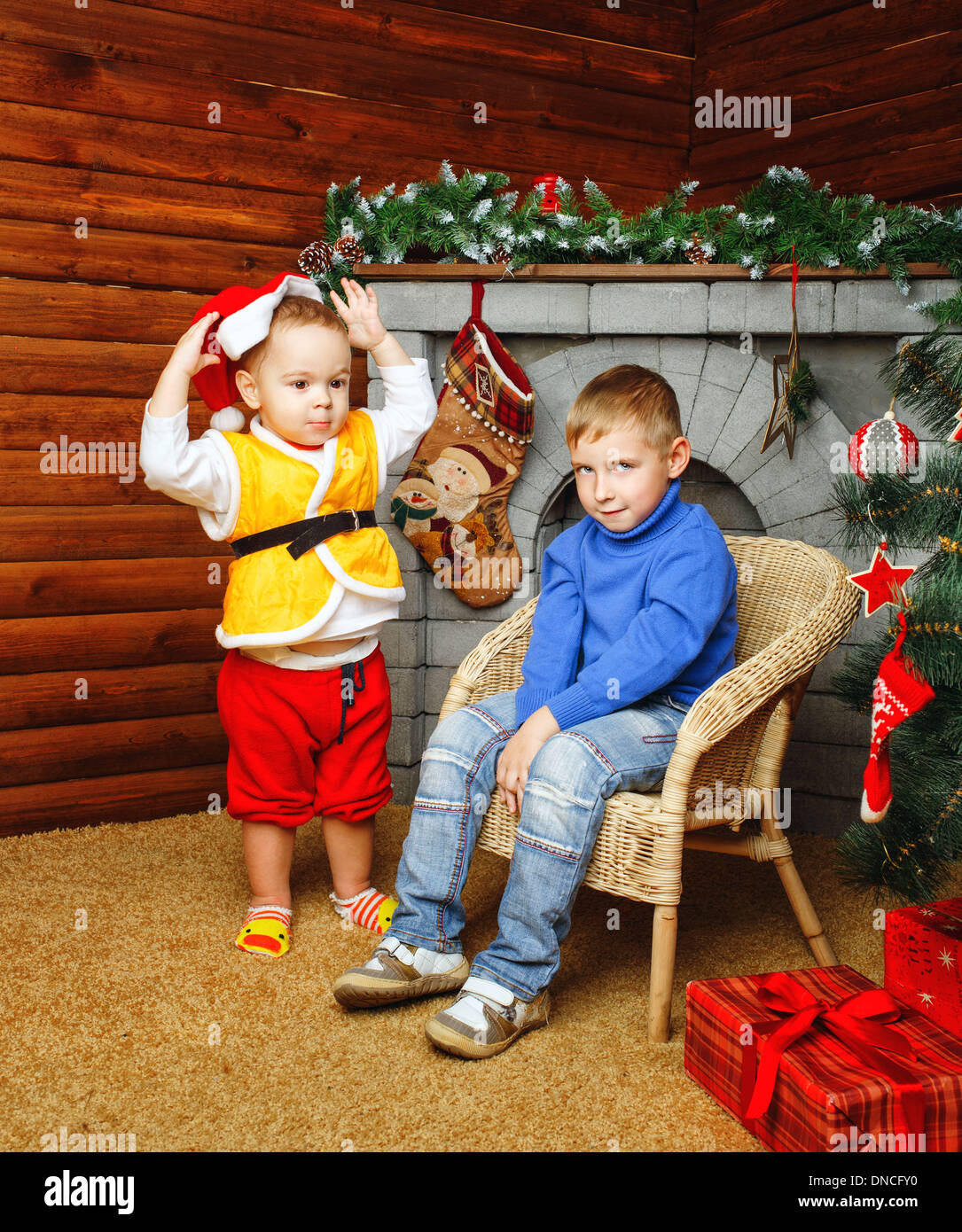 Two brothers near decorated Christmas tree pending holiday Stock Photo ...