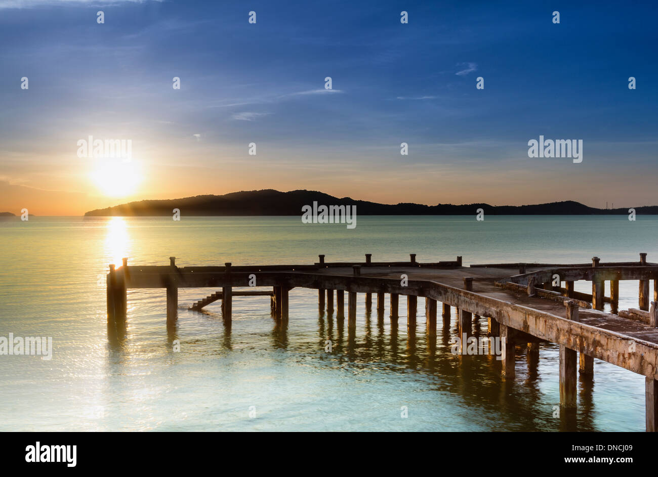 Old jetty between sunrise Stock Photo - Alamy