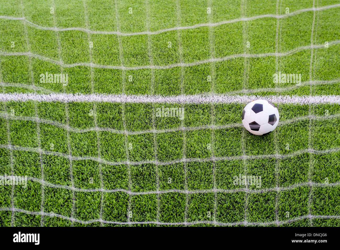 Soccer ball in goal Stock Photo - Alamy