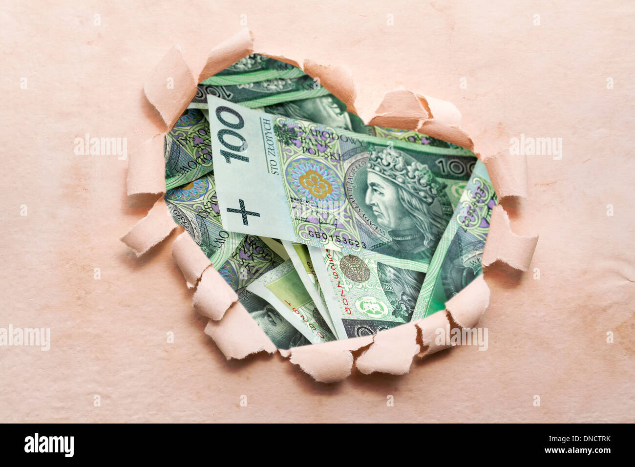 Heart ripped out in the paper and in the middle of the money Stock ...