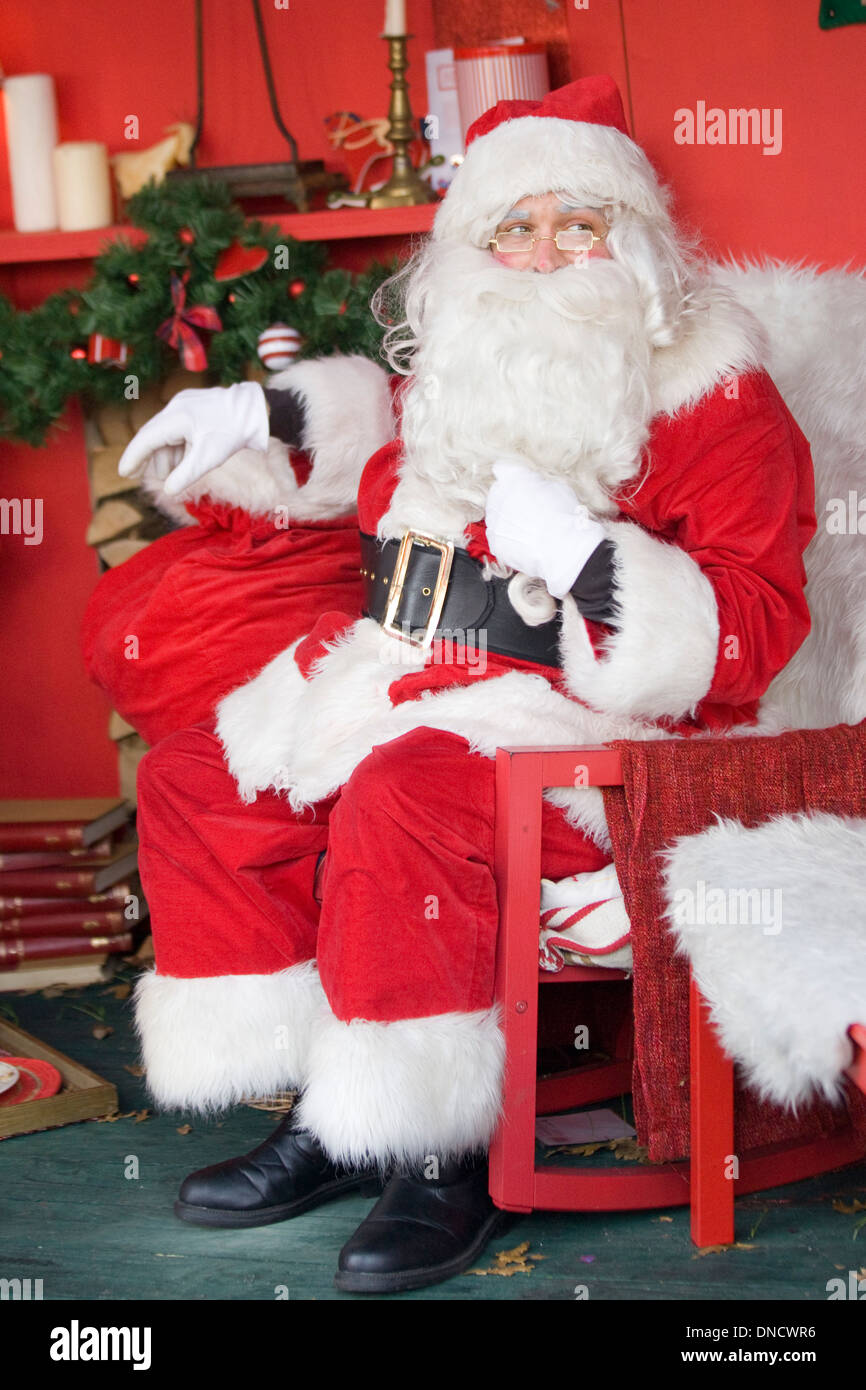 Father Christmas giving Presents to Children in Santa's grotto London ...