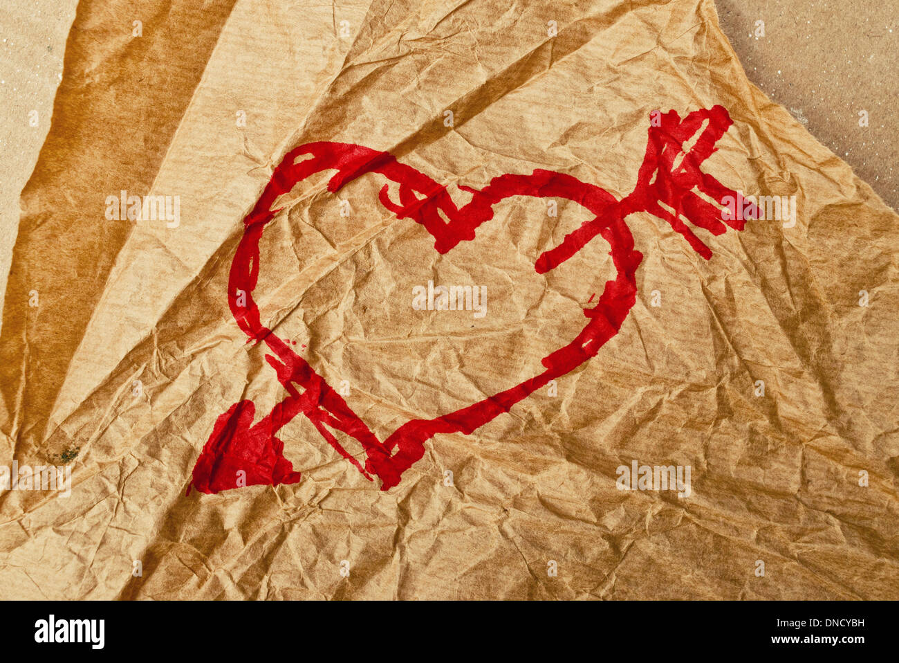 Heart and arrow drawing on old crumpled paper texture Stock Photo - Alamy