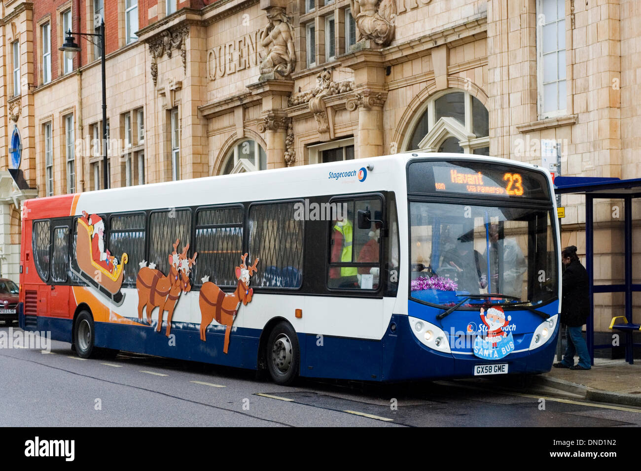 stagecoach bus decorated as a seasonal santa bus picks up passengers ...