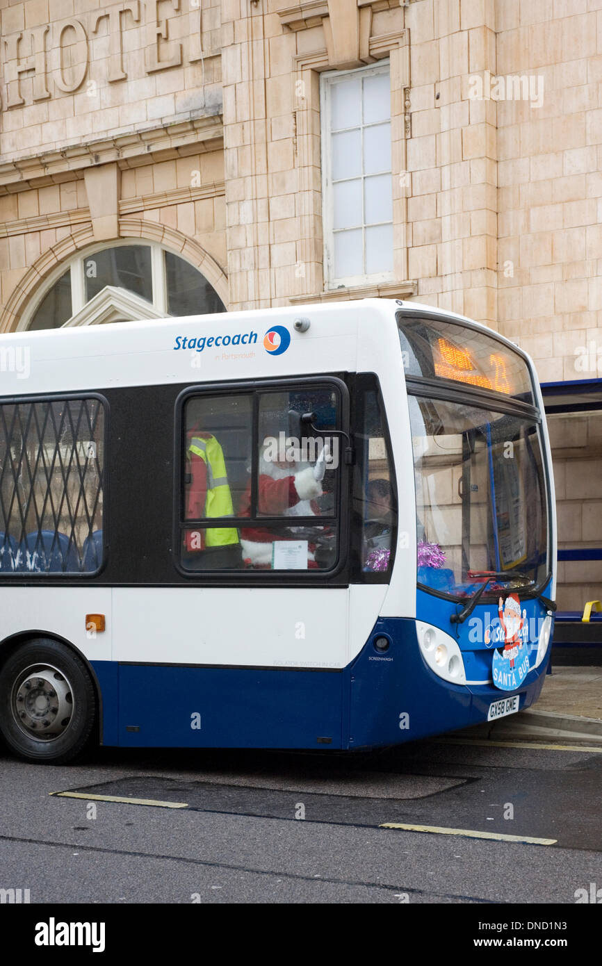 stagecoach bus decorated as a seasonal santa bus picks up passengers in ...
