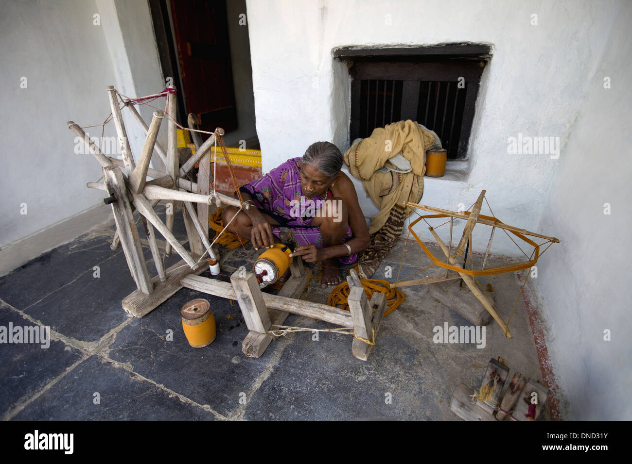 Tribal woman making thread on Charkha, the spinning wheel, Orissa ...