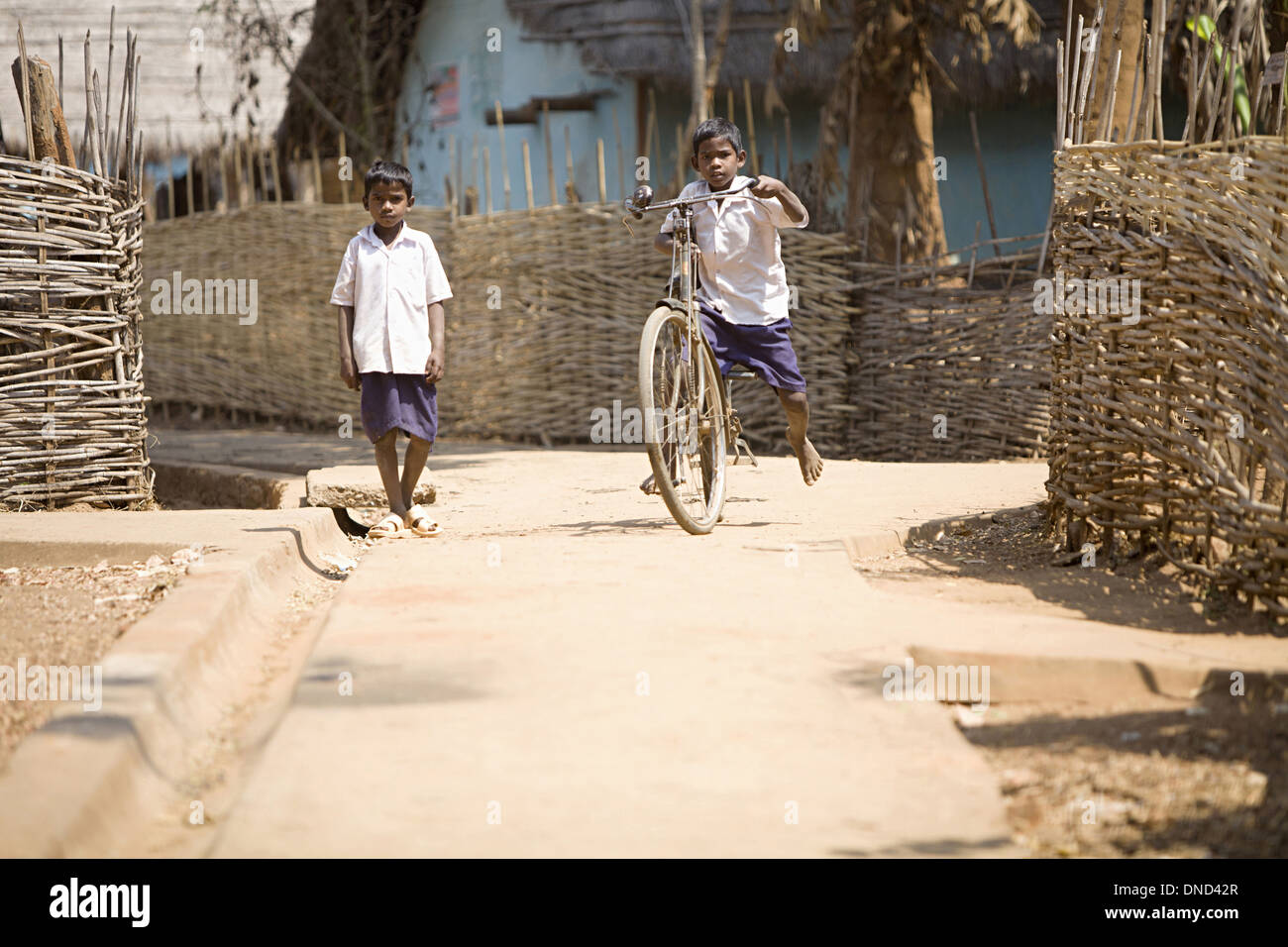 Tribal children riding cycle, Orissa, India Stock Photo - Alamy