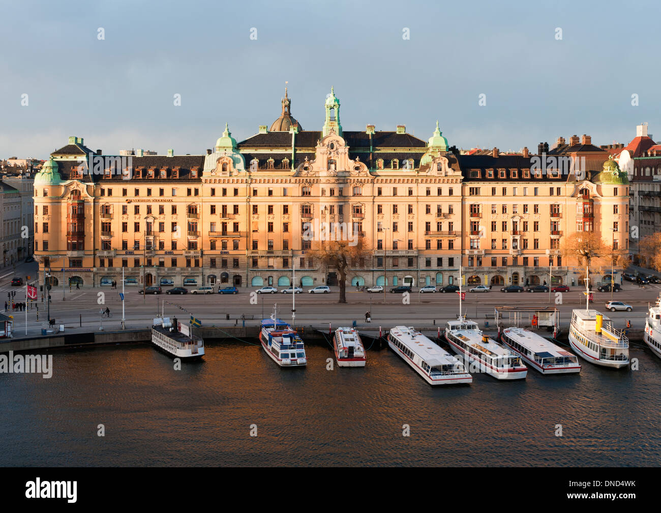 Small ferry boats moored in Nybroviken bay, with the Art Nouveau ...