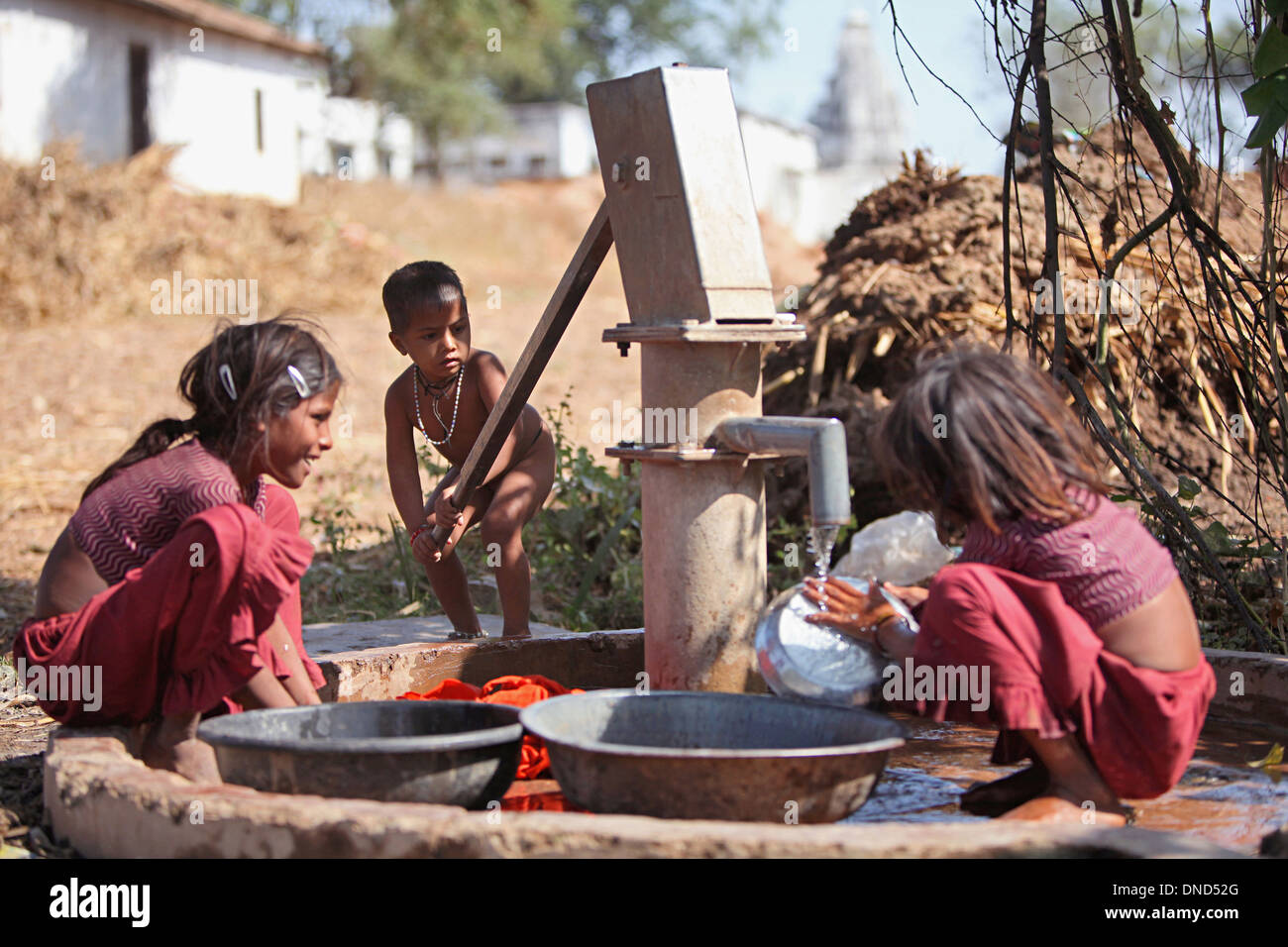 Bhil girl cleaning utensils, Bhil tribe, Madhya Pradesh, India Stock ...