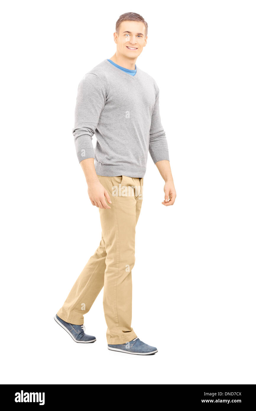 Full length portrait of a confident casual guy walking and looking at ...
