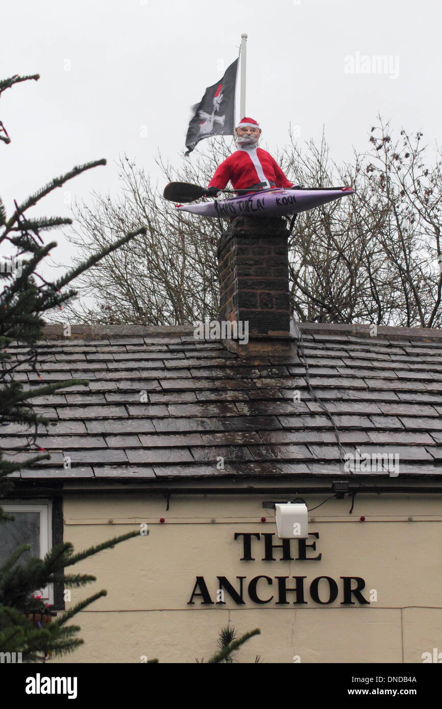 Tideswell, Derbyshire, UK. 23 December 2013. Santa sits in a canoe ...