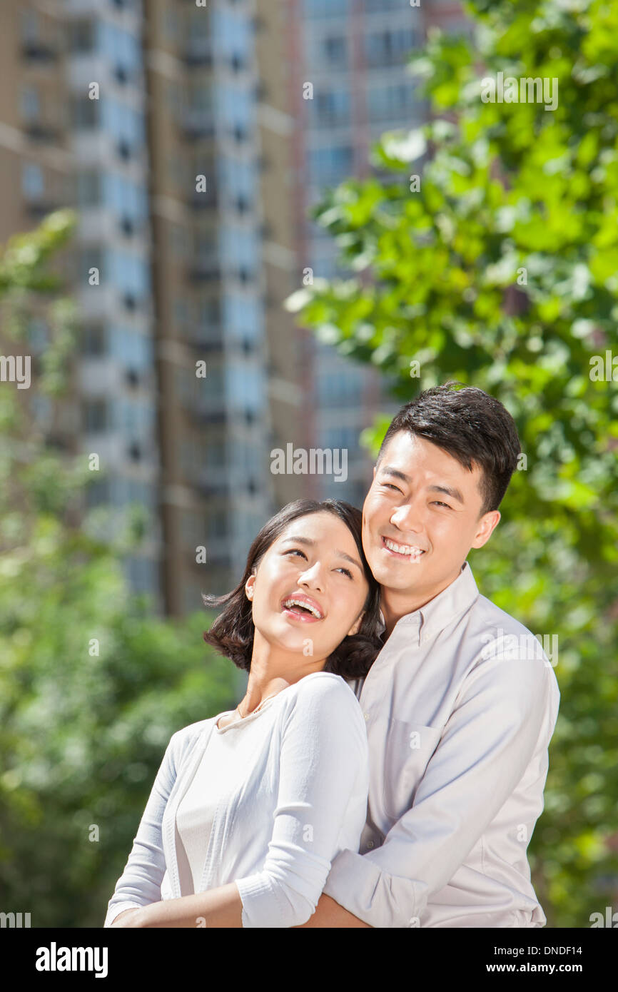 Sweet young couple arm around outdoors Stock Photo - Alamy
