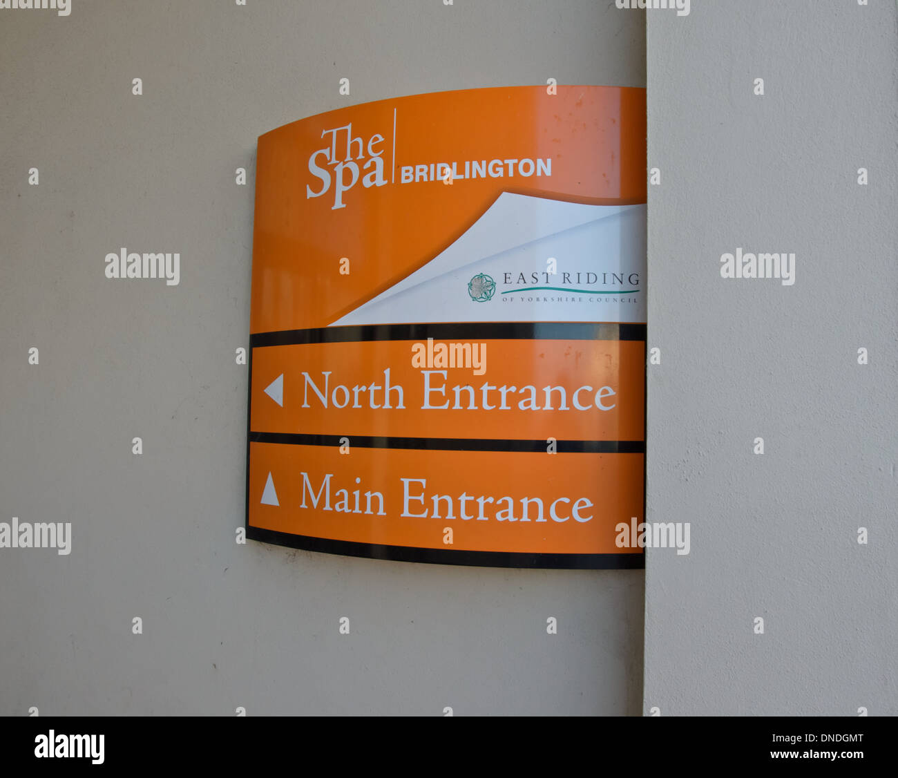 Wall mounted sign directions signpost at the exterior entrance to ...