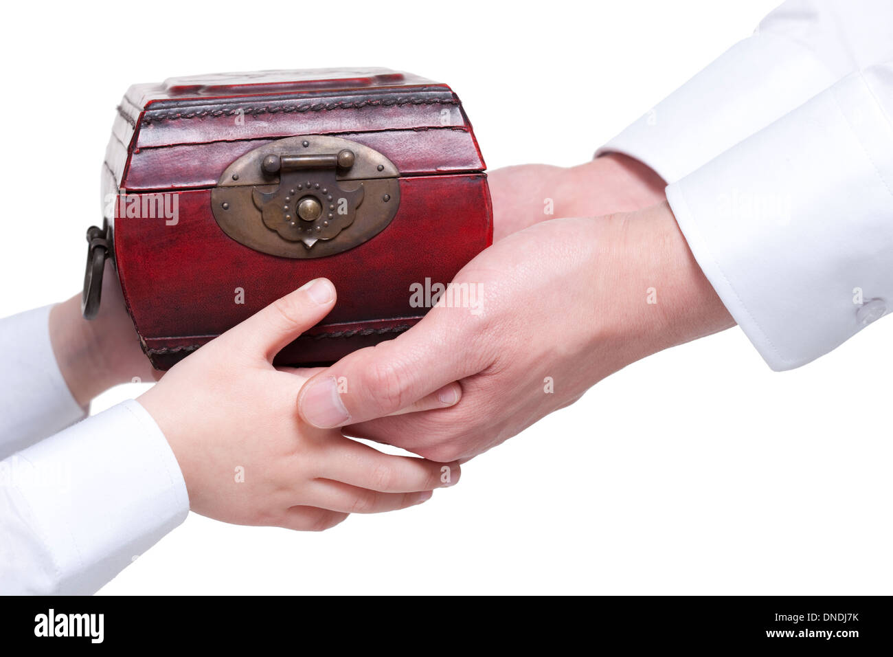 Adult passing treasure chest on to child Stock Photo - Alamy