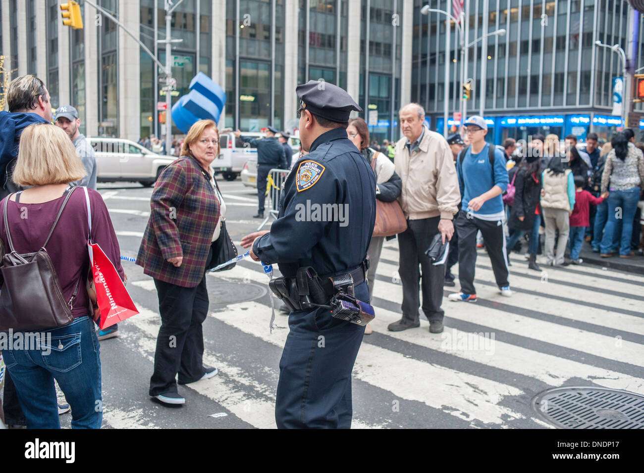 NYPD officers use police tape and barricades to control the hordes of ...