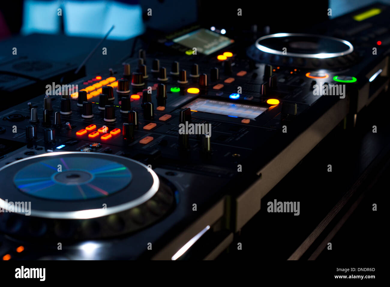 Music deck at a disco with two turntables and multiple switches and ...