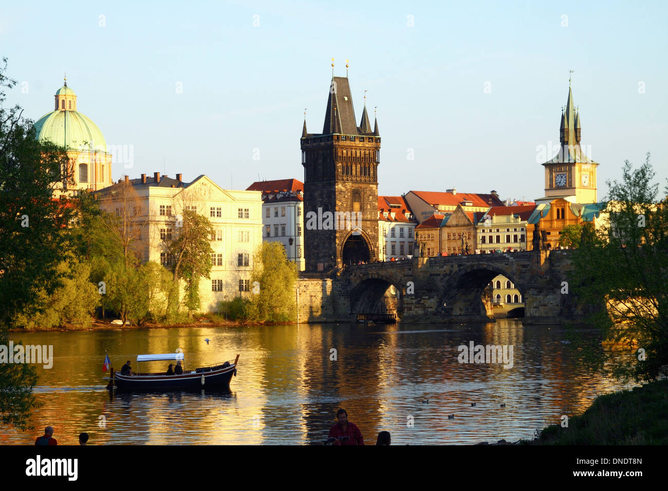 Boat sailing through Vltava river nearby Charles Bridge in Prague Czech ...