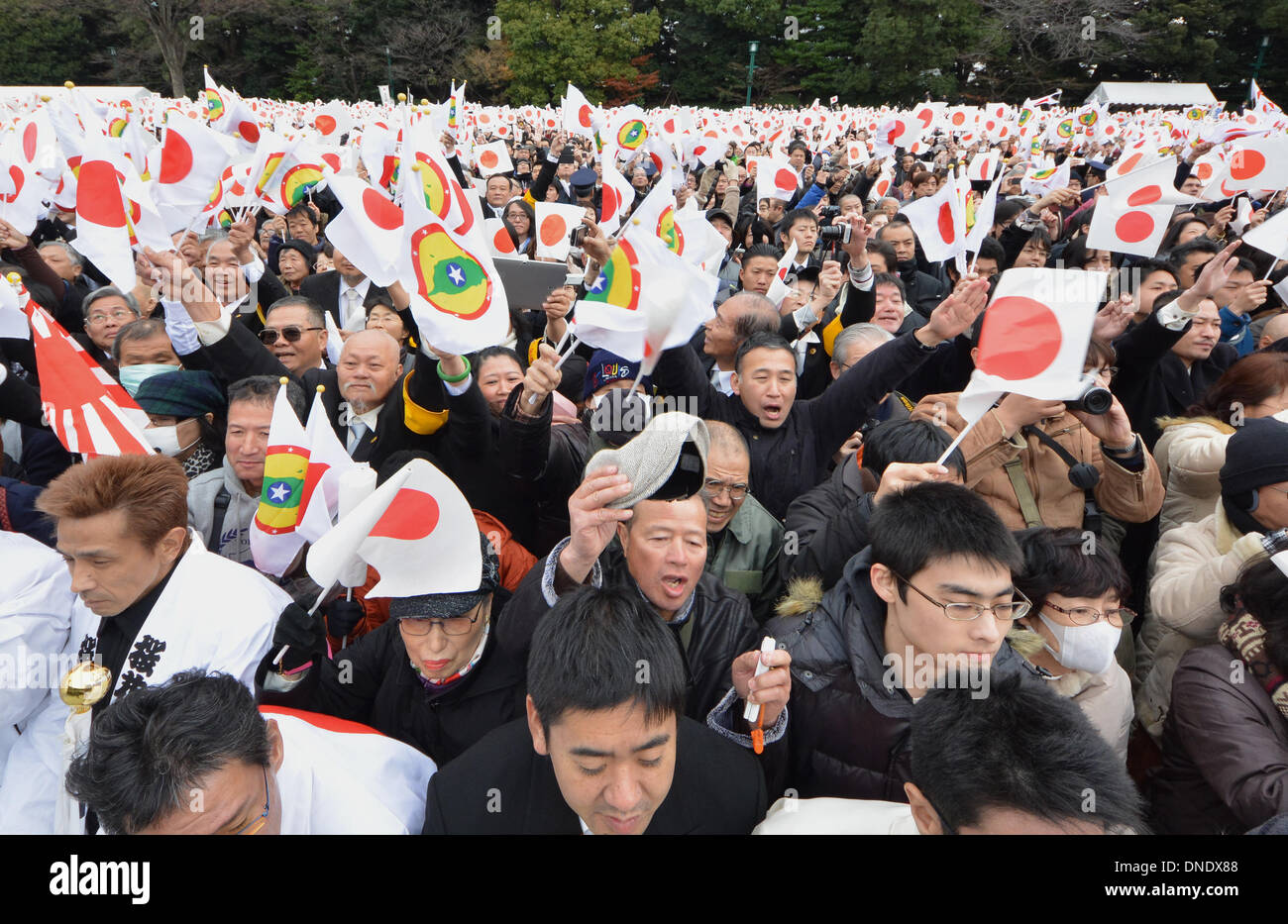 Tokyo, Japan. 23rd Dec, 2013. Well-wishers wave paper flags ...