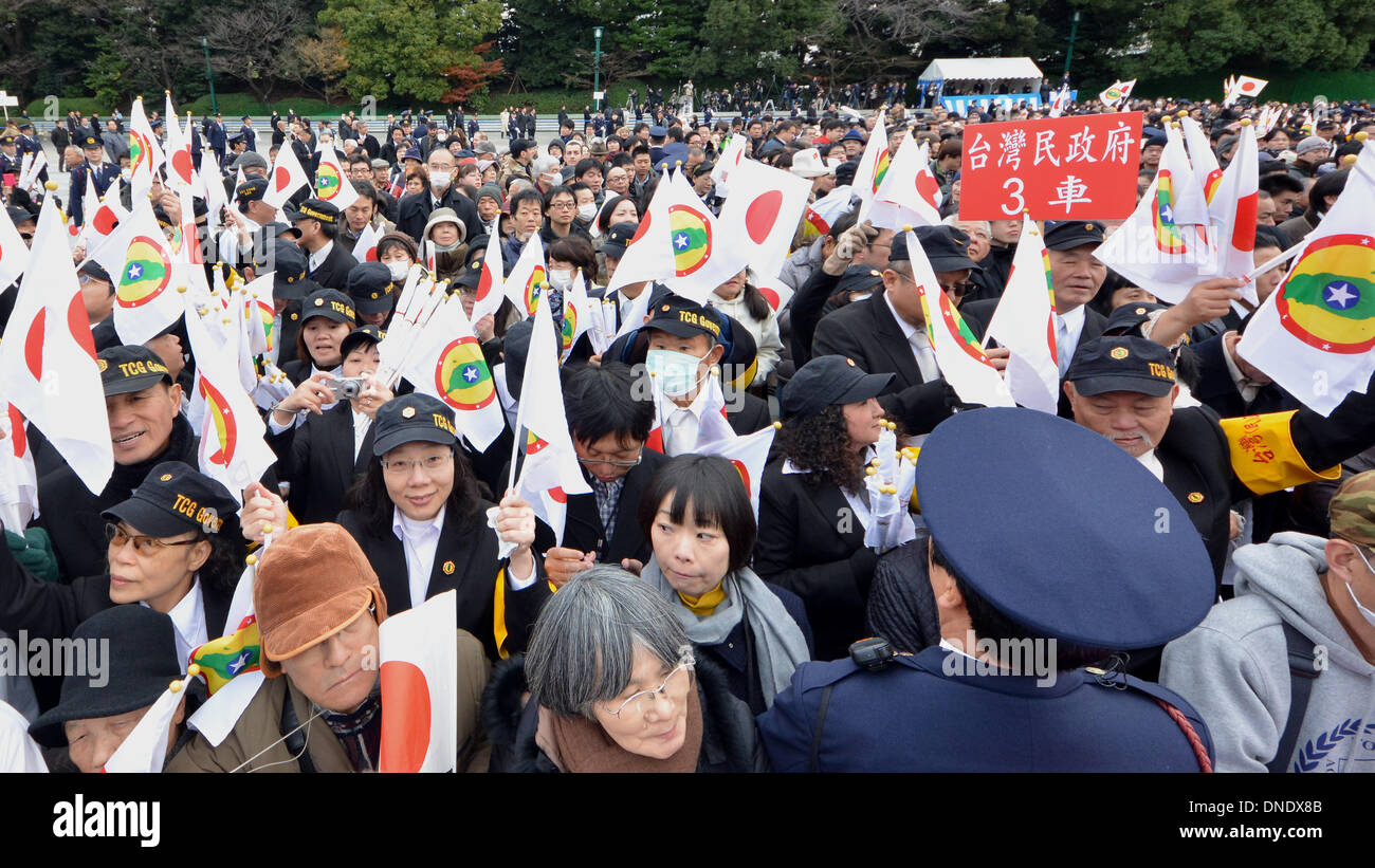 Tokyo, Japan. 23rd Dec, 2013. Well-wishers wave paper flags ...