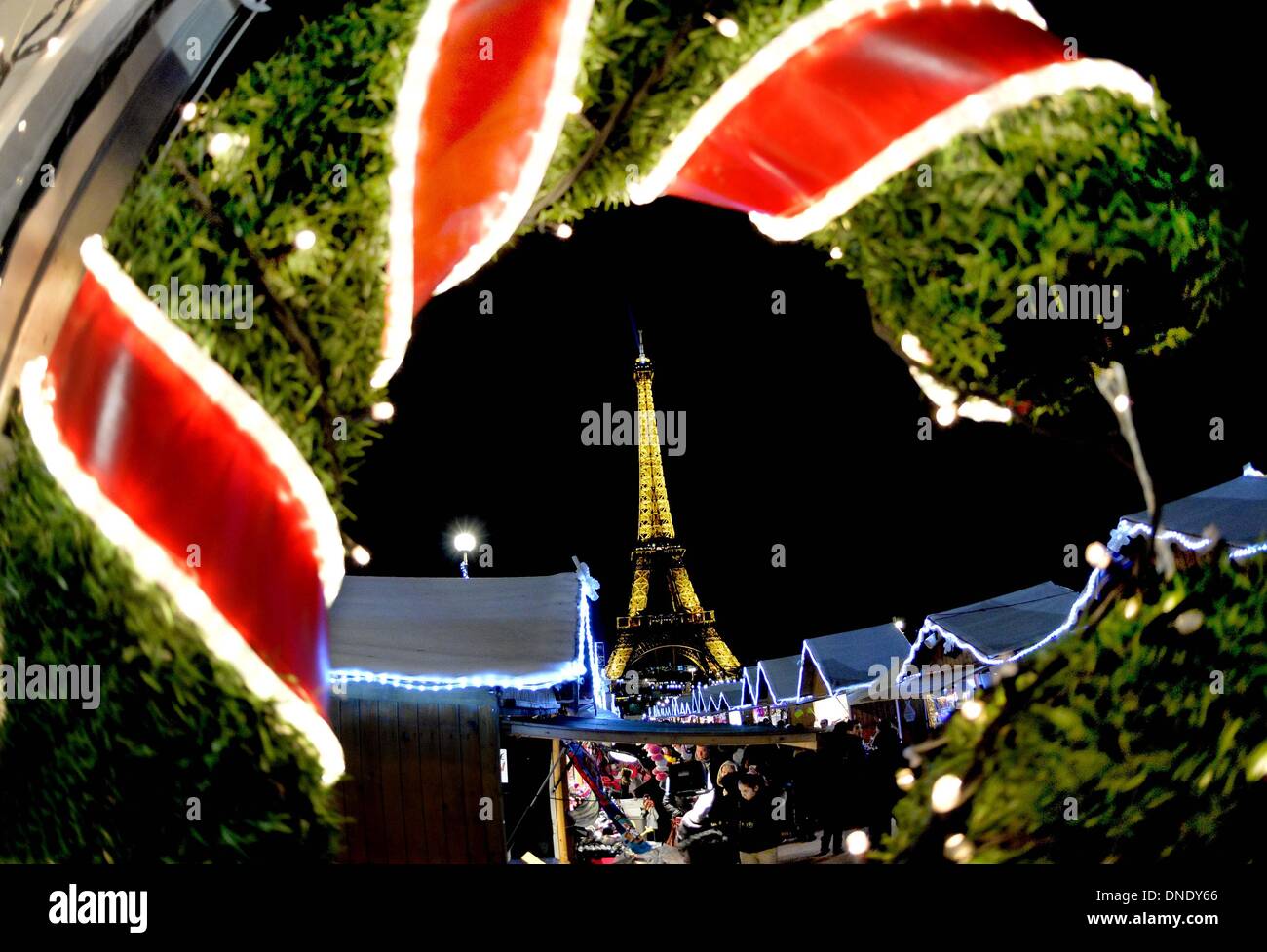 Paris, France. 23rd Dec, 2013. People shop at a night market in front ...