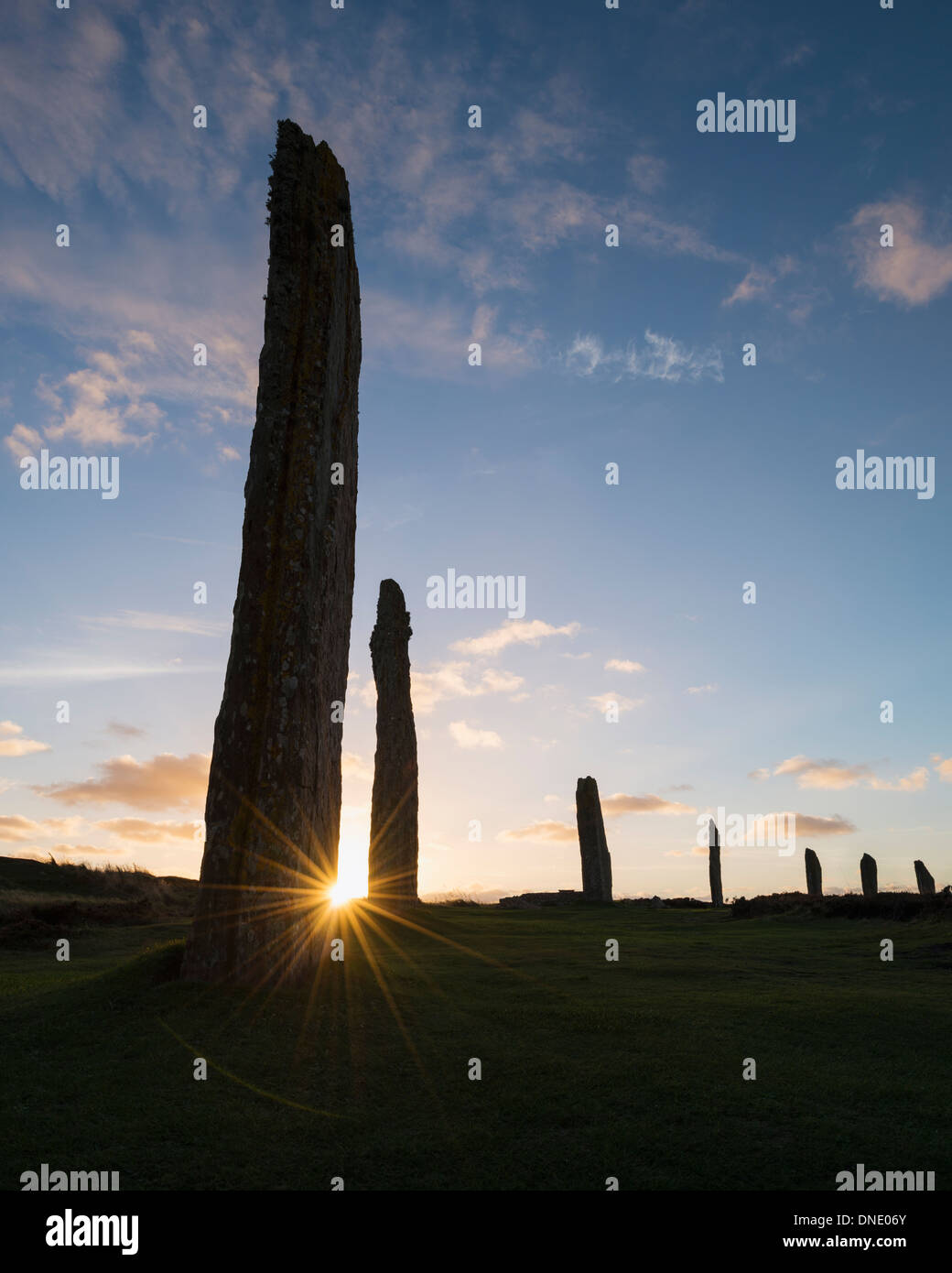 Setting sun shines behind standing stone at Ring of Brodgar, Orkney ...