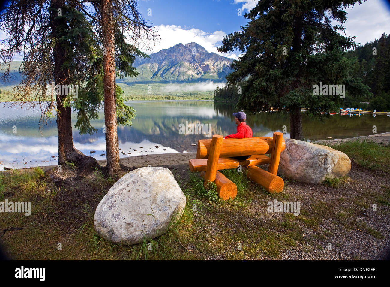 Middle age male sitting on bench at Pyramid Lake looking at Pyramid ...