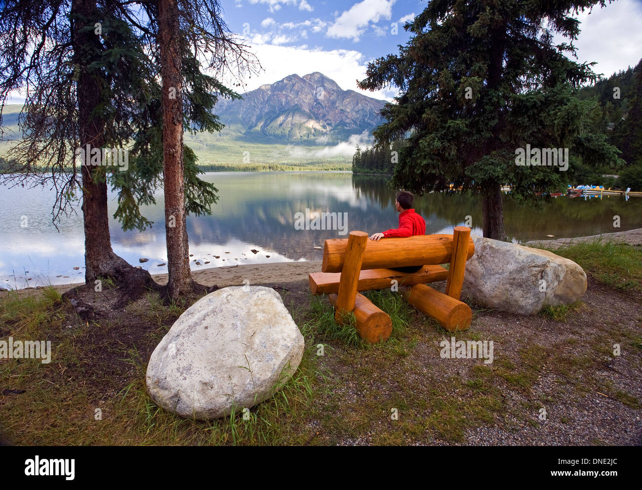 Middle age male sitting on bench at Pyramid Lake looking at Pyramid ...
