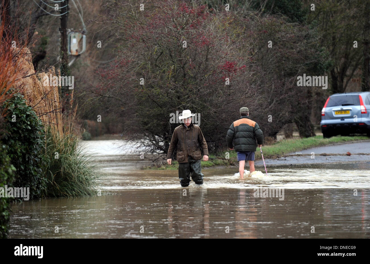 Residents wade through flooded roads around the village of Barcombe and ...