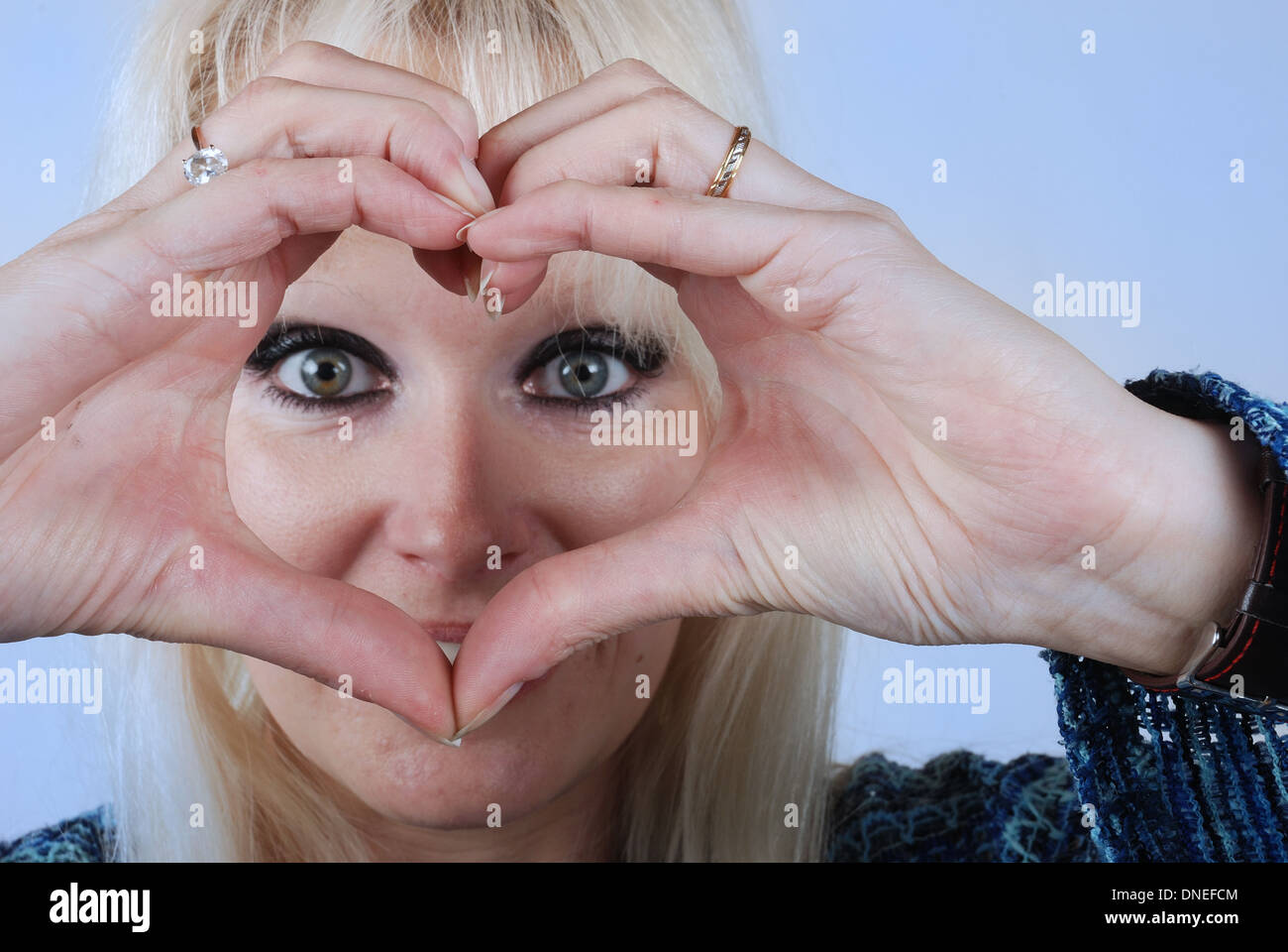 Woman making heart shape with her hands Stock Photo - Alamy