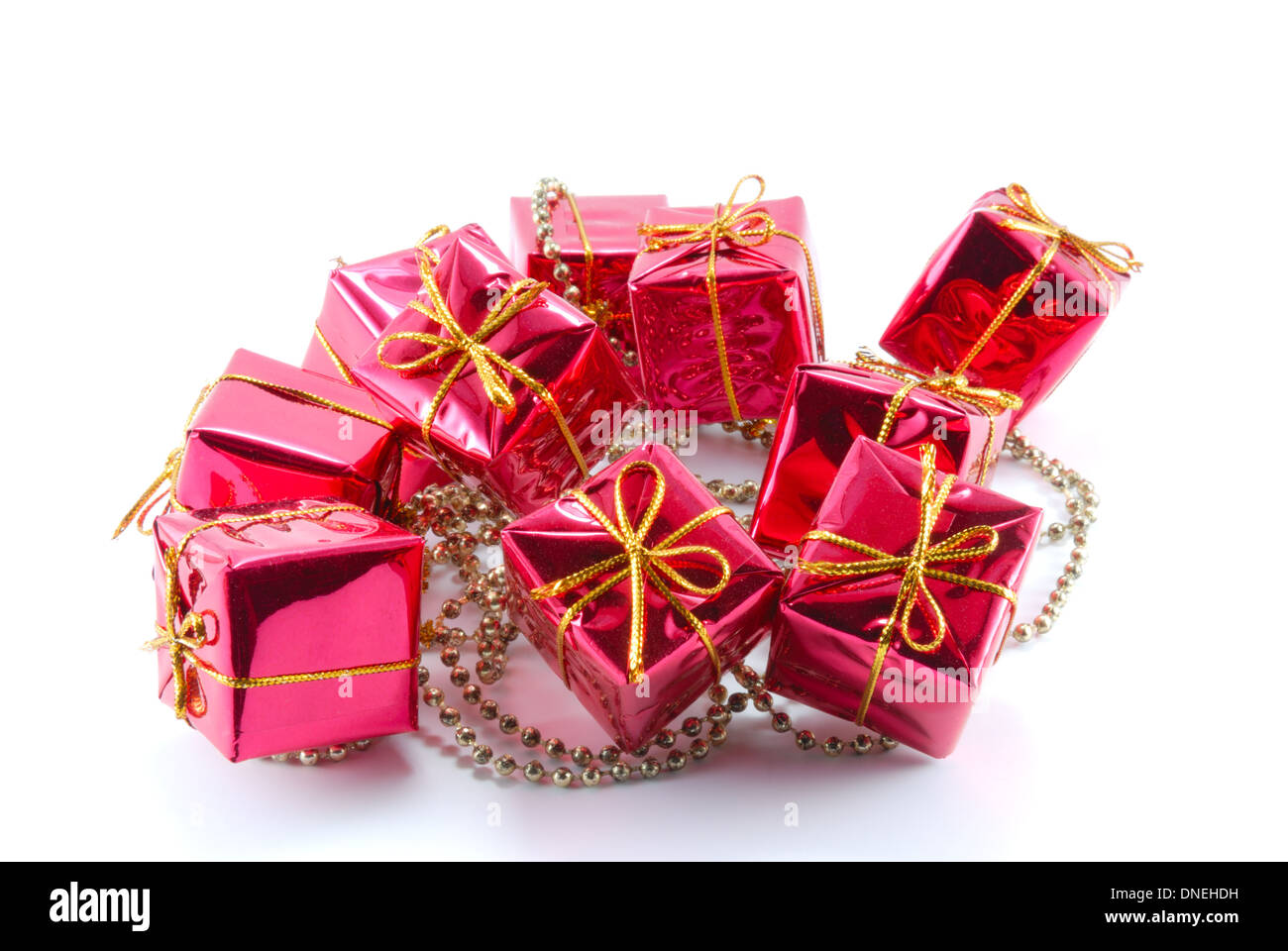 Small gift boxes with a chain on a white background Stock Photo - Alamy